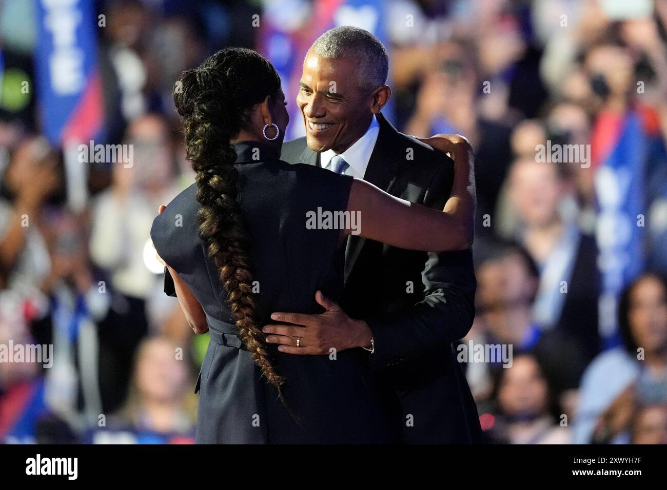 Former President Barack Obama hugs his wife Former First Lady Michelle ...
