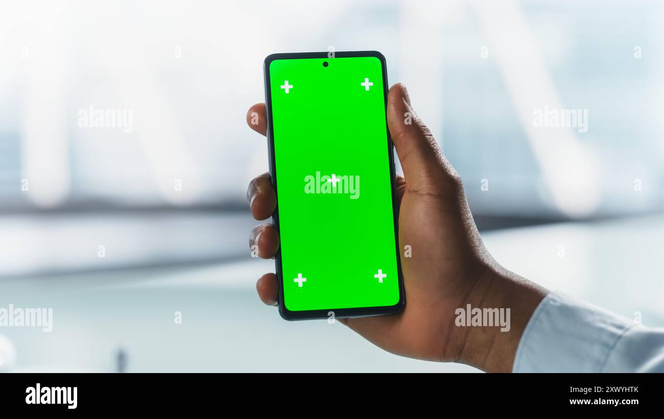 Anonymous Businessman Holding Smartphone with Green Screen Mock Up ...