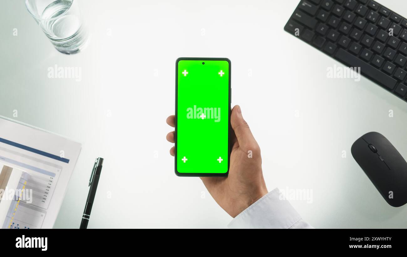 Top Down View of a Person Holding a Smartphone with Mock Up Green ...