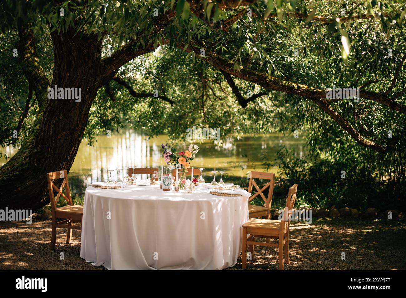 beautiful wedding decor. tables under the tree in the garden. High ...