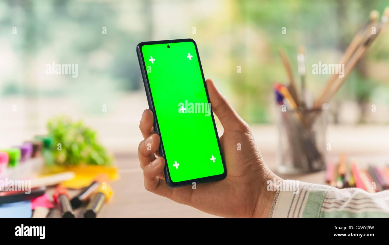 Creative Scholar Checking a Social Network Post on Smartphone with Mock ...