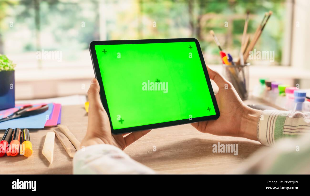 Anonymous Arts Teacher Holding Tablet Computer with Green Screen Mock ...