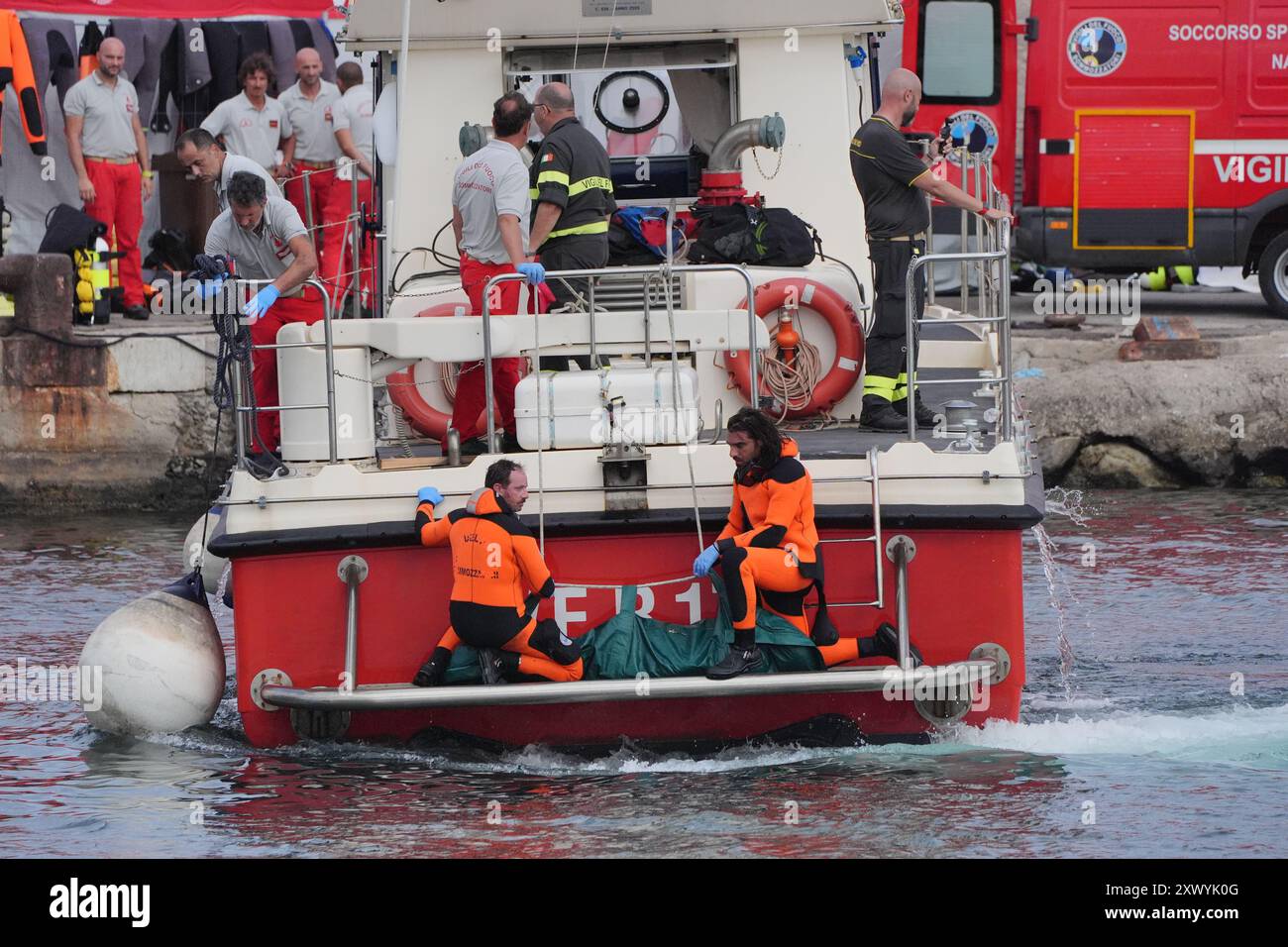 A body bag is brought ashore at the harbour in Porticello by rescue ...