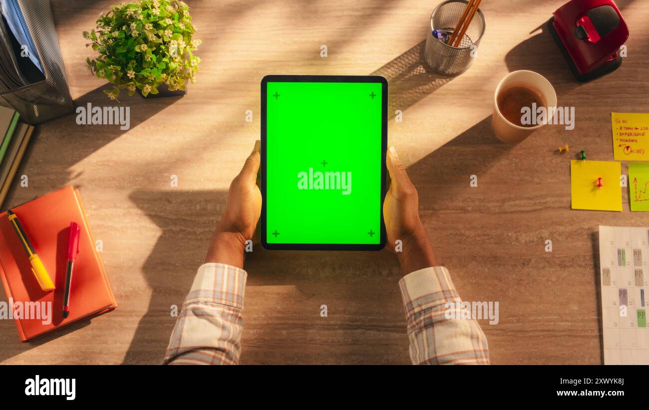 Anonymous Office Worker Using Tablet Computer with Green Screen Mock Up Display for Social Media ...