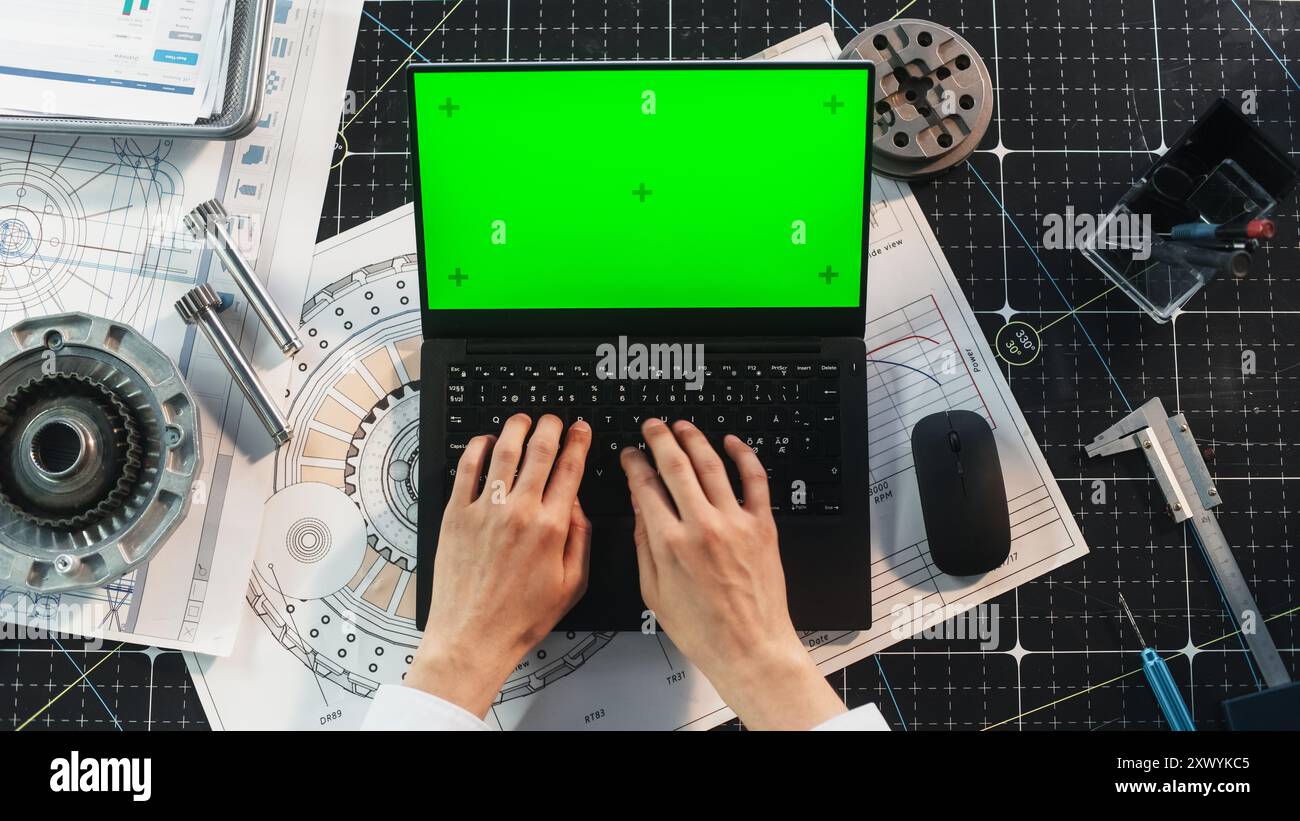 Anonymous Engineer Typing on a Laptop Computer with Mock Up Green ...