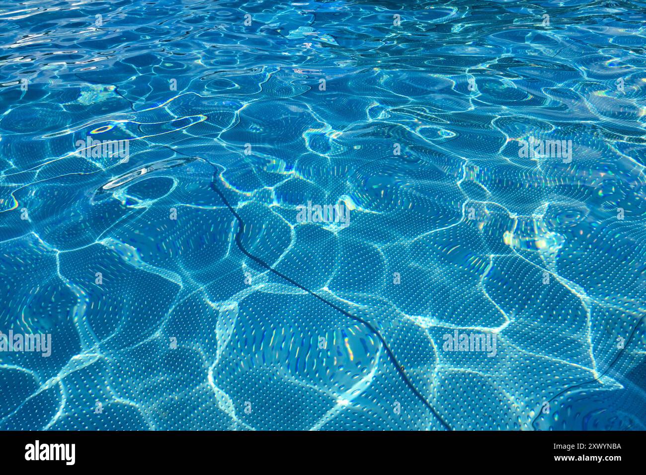 Transparent blue water in the pool. Water background. Refraction of ...