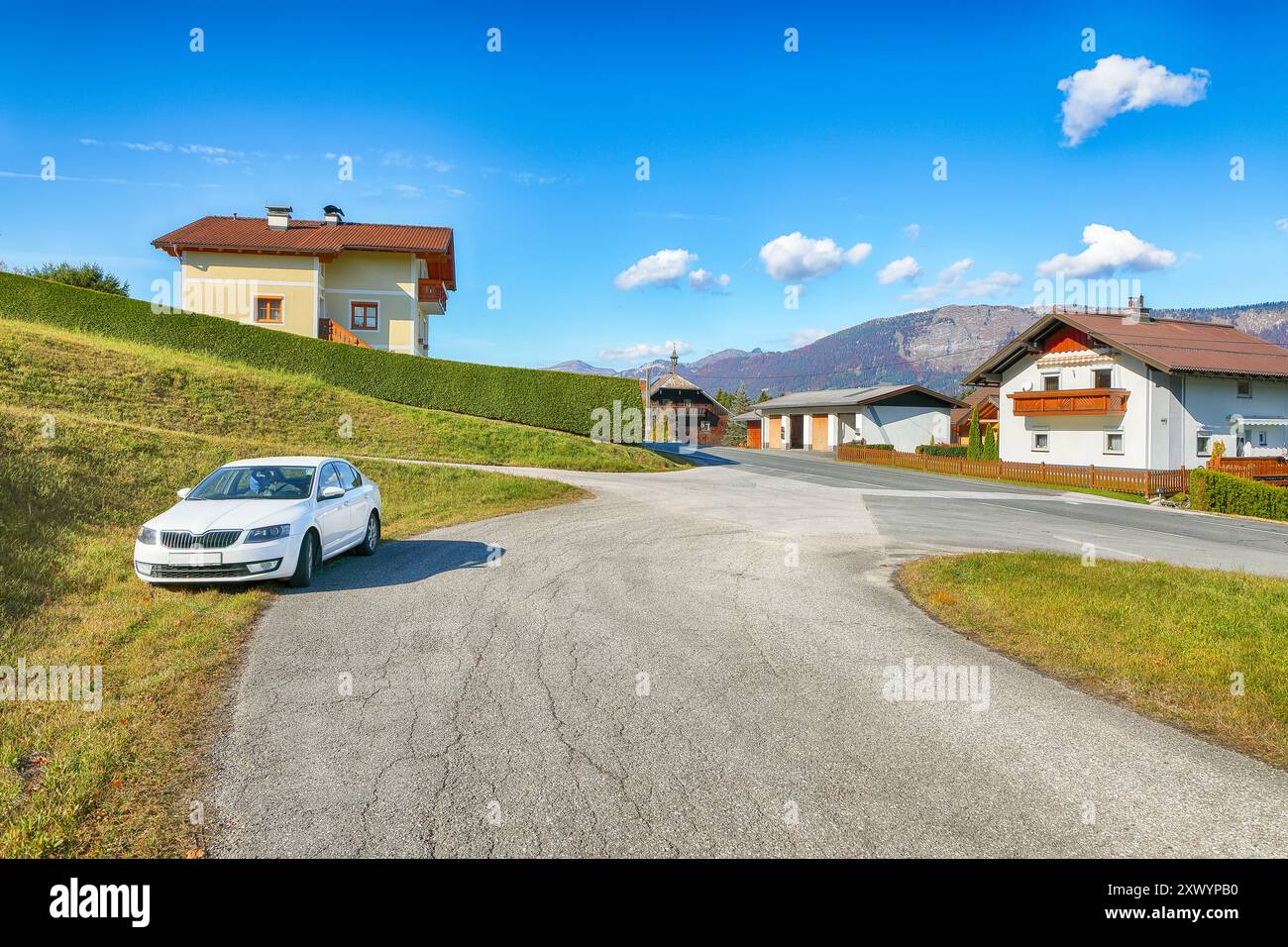 Captivating view of Alpine green fields and traditional wooden houses ...