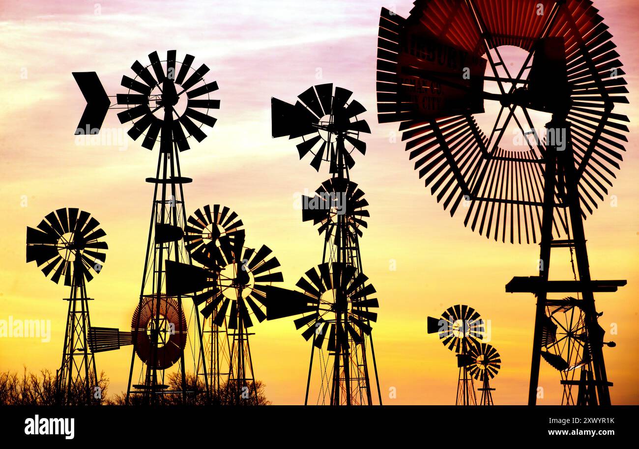 The sun sets to silhouette a variety of windmills erected on the grounds of the American ...