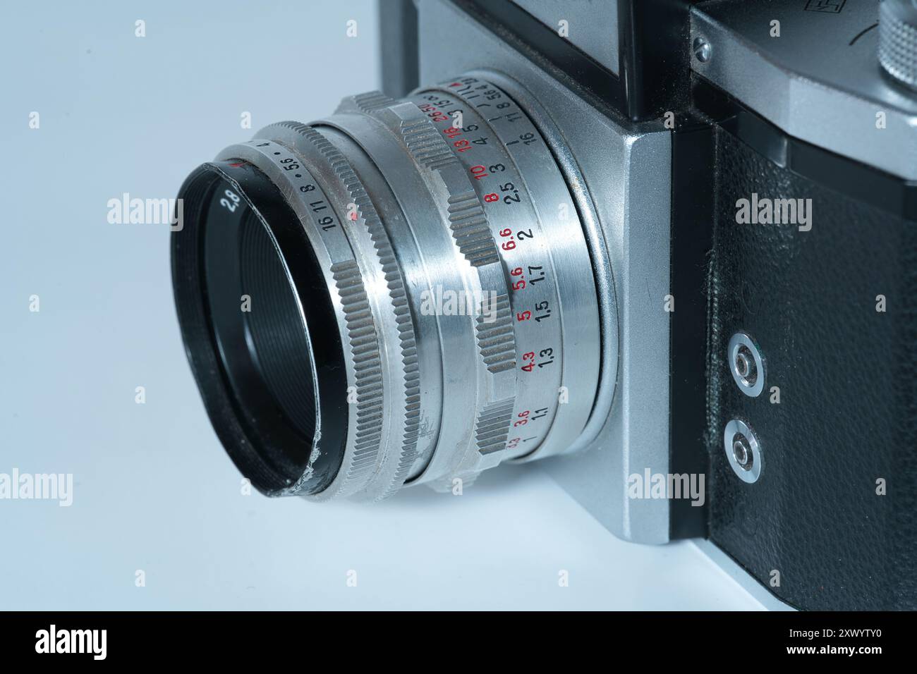 close-up of an analog lens on a camera in front of a white background ...