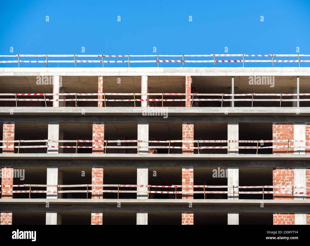 A multi-story building under construction features exposed brickwork ...