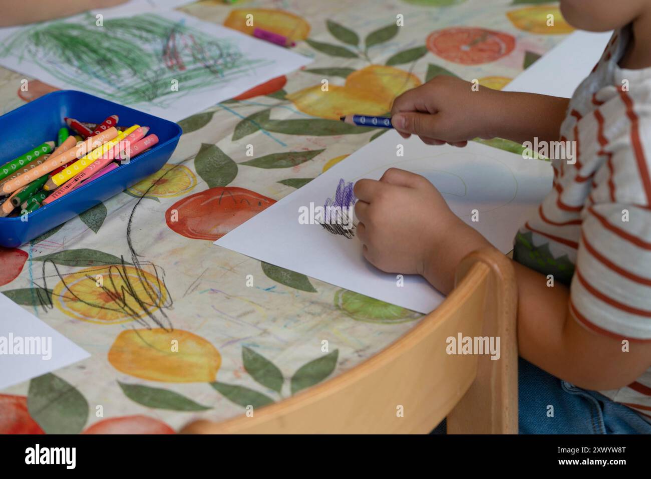 A child paints with colored pencils, general, feature, marginal motif ...