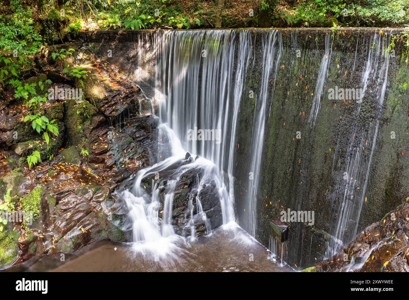 Water dam on a river where a waterfall is produced to feed the water ...
