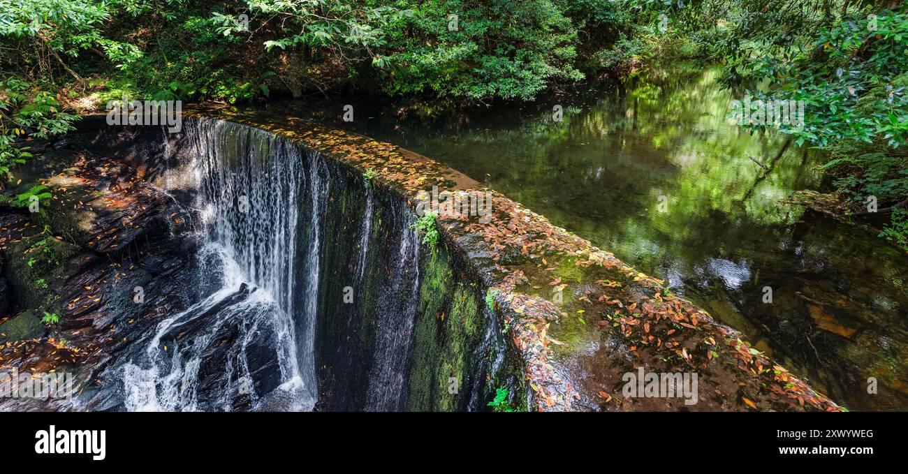 Water dam on a river where a waterfall is produced to feed the water ...