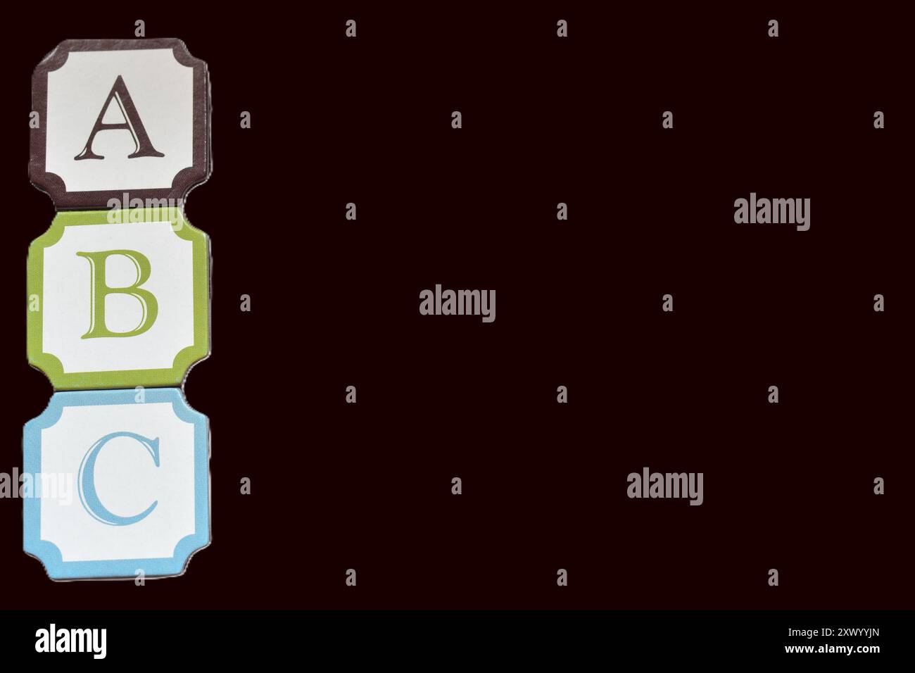 Isolated ABC in multi-colored block letters, on a black background ...