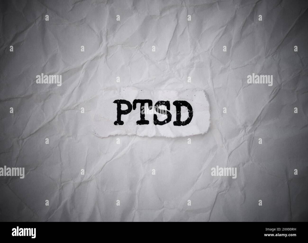 Crumpled piece of paper with letters PTSD on a crumpled white paper ...
