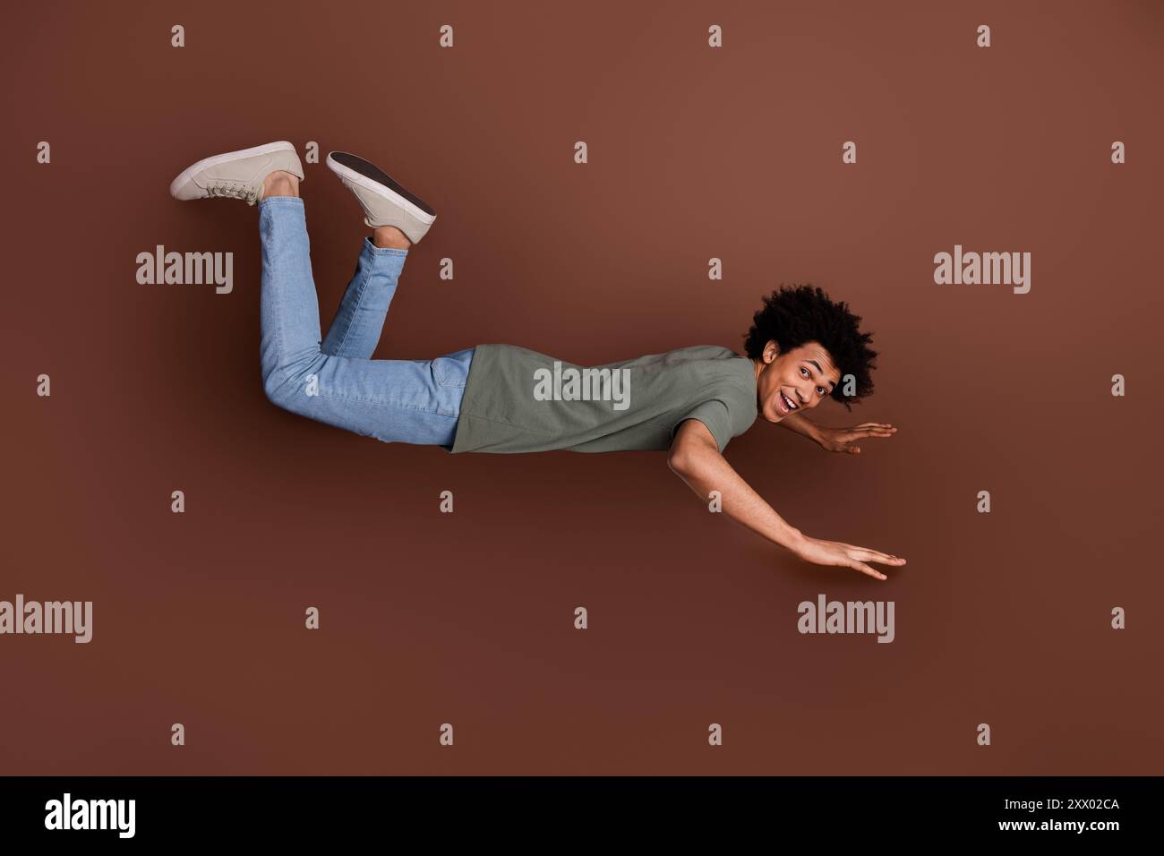 Full body photo of attractive young man falling down flying dressed ...