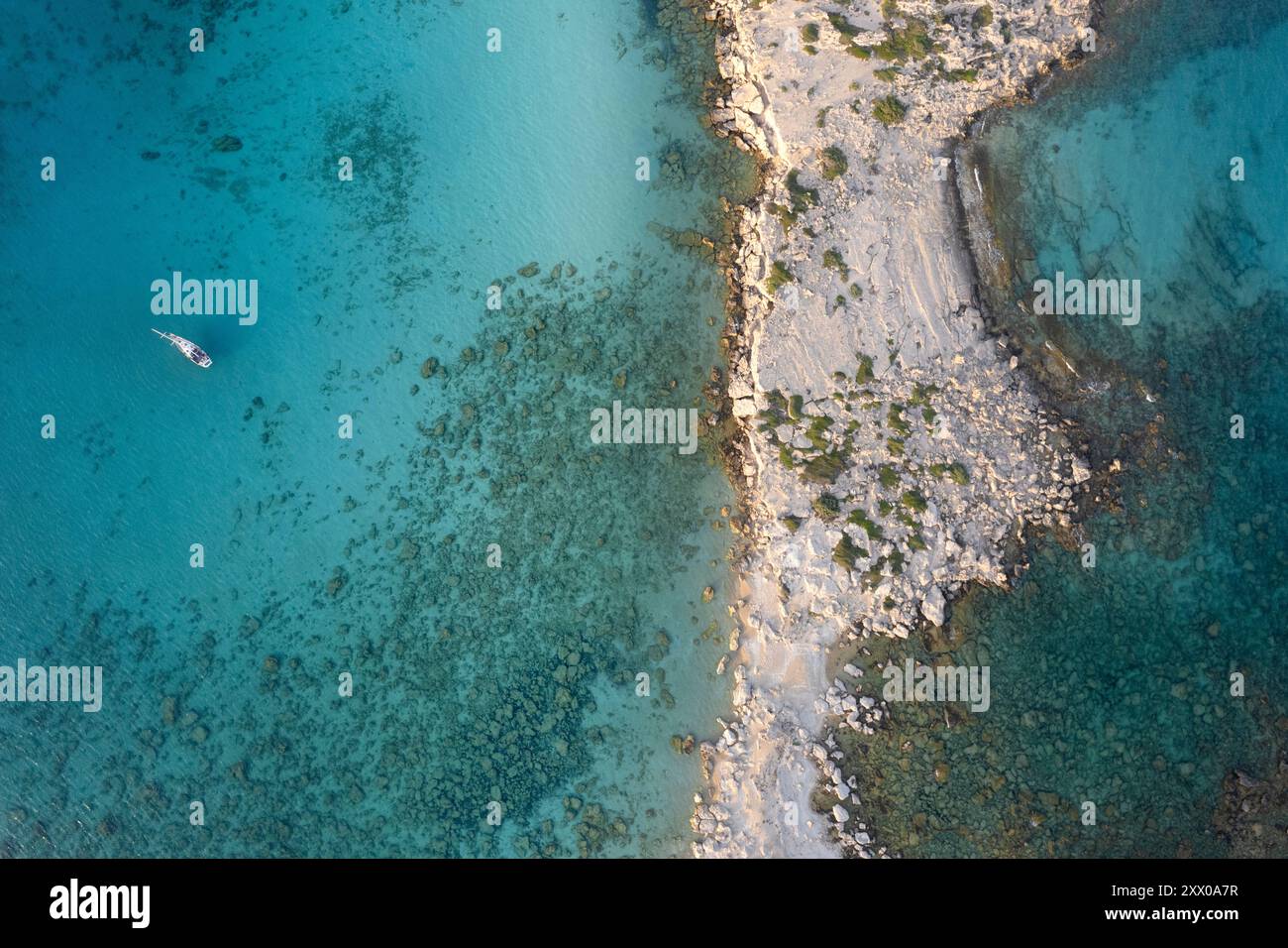 Aerial view of sailing boat at anchor close to the island of Gyali ...