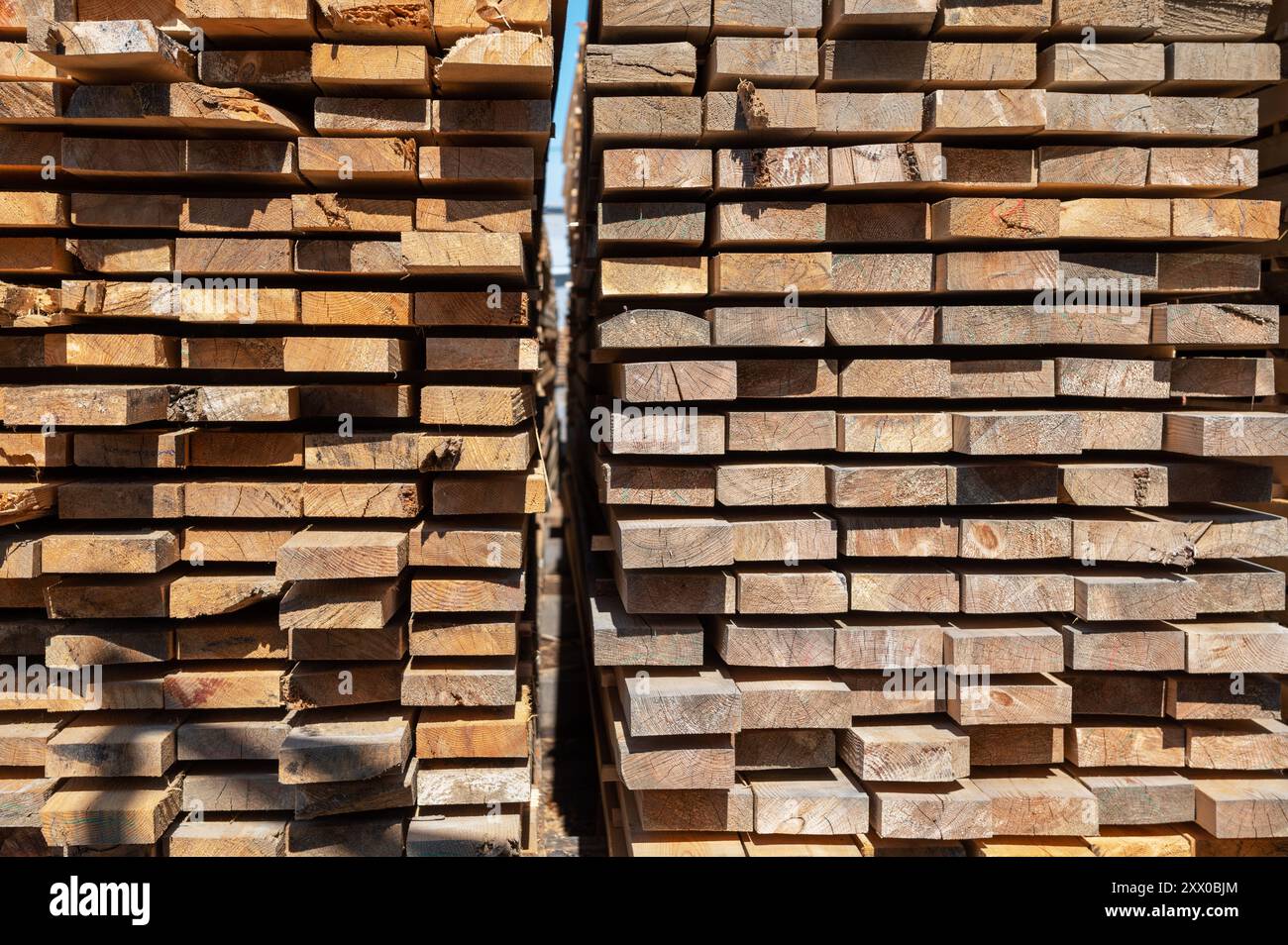 Stacked wooden planks close-up at lumber warehouse. Wood industry ...