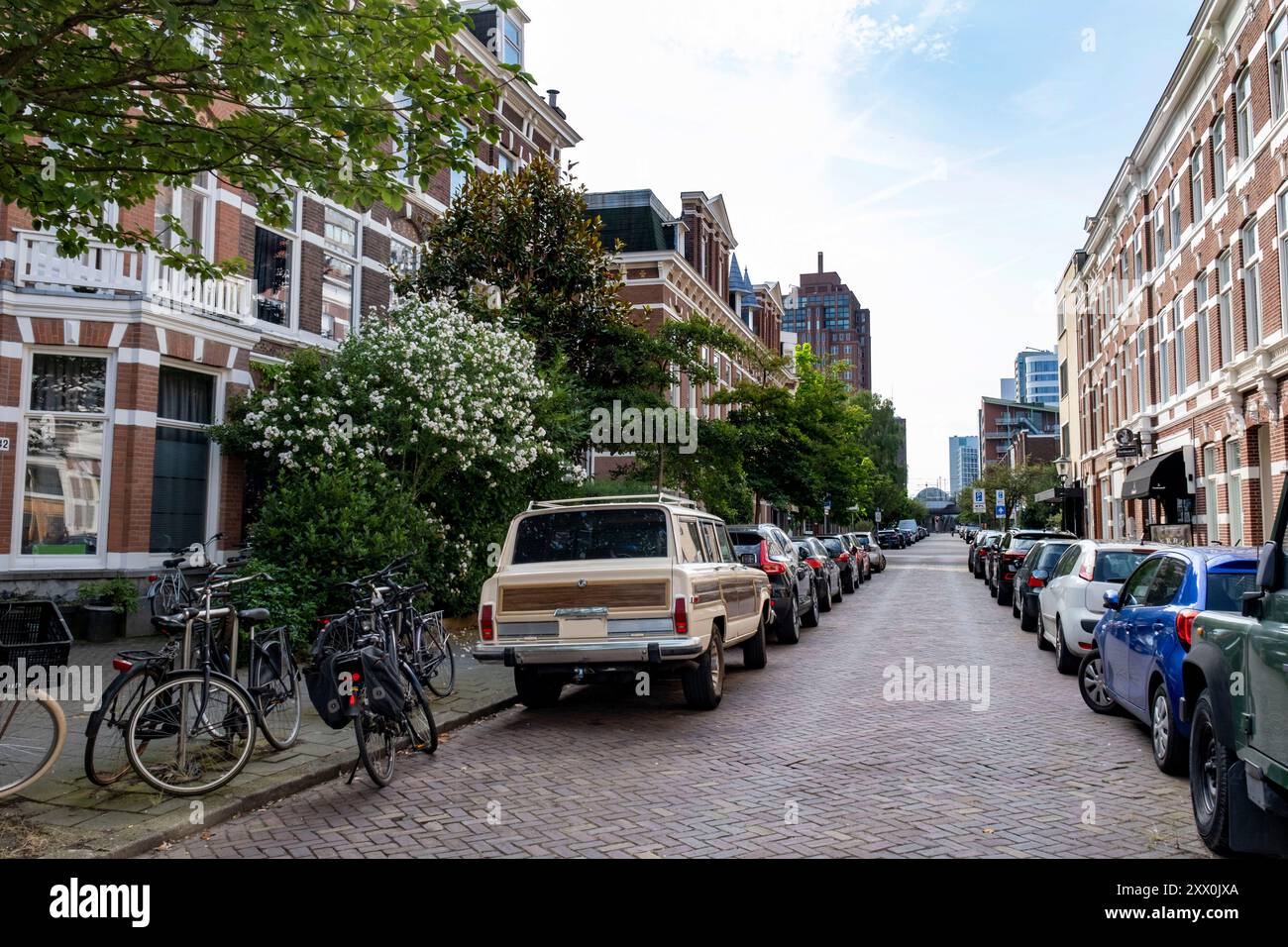 Typical Dutch cityscape on the sunny day with streets, a calm canal ...
