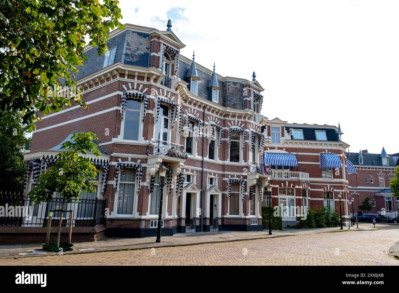 Typical Dutch cityscape on the sunny day with streets, a calm canal ...