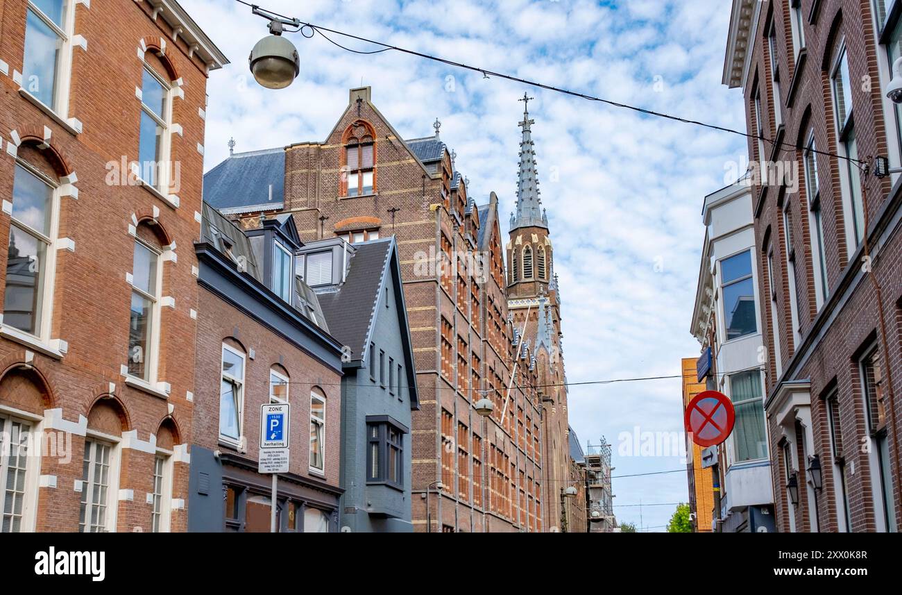 Typical Dutch cityscape on the sunny day with streets, a calm canal ...