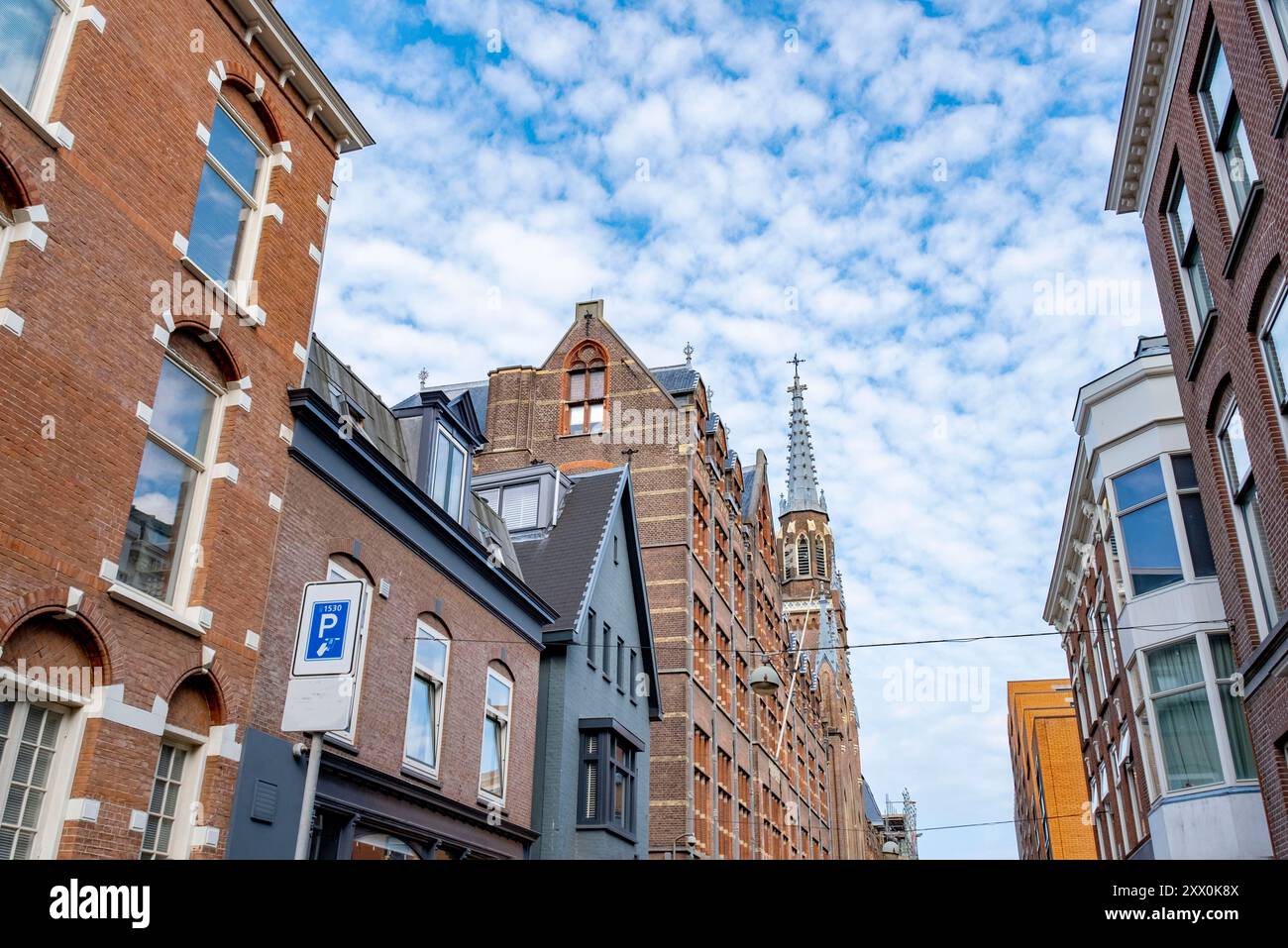 Typical Dutch cityscape on the sunny day with streets, a calm canal ...