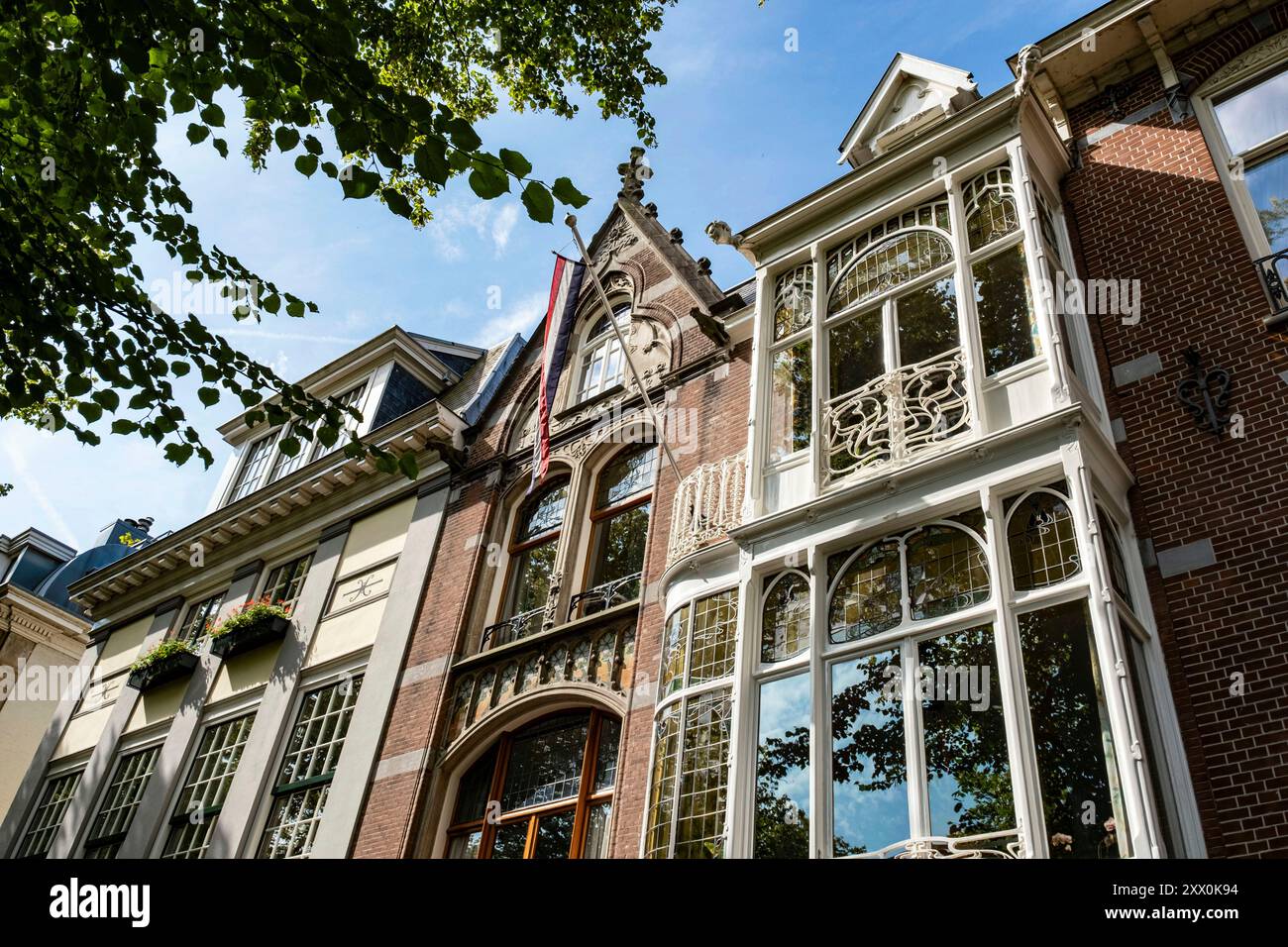 Typical Dutch cityscape on the sunny day with streets, a calm canal ...