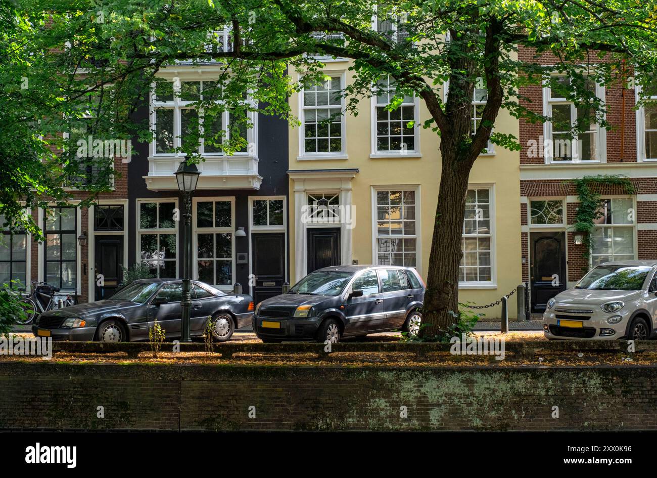 Typical Dutch cityscape on the sunny day with streets, a calm canal ...