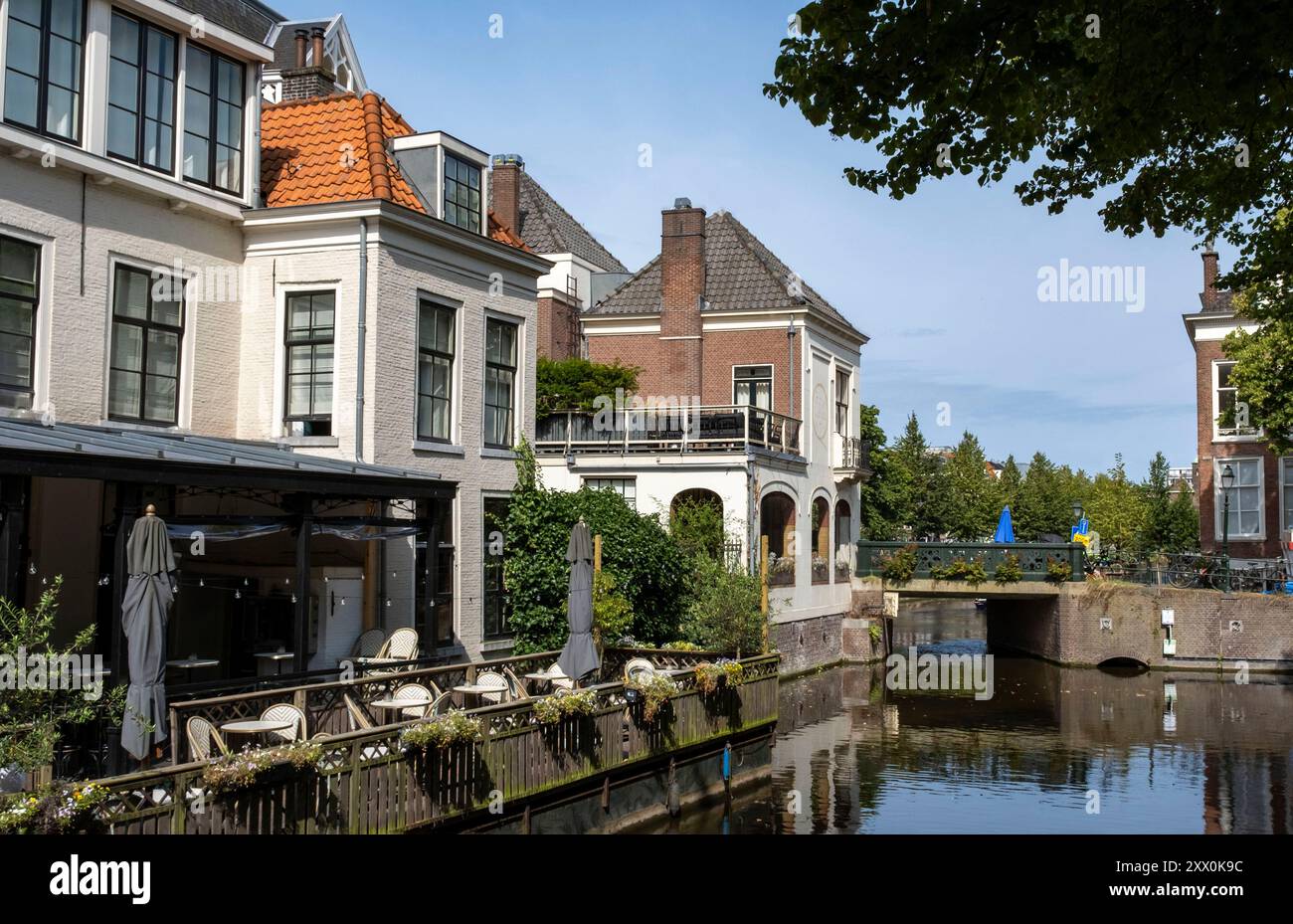 Typical Dutch cityscape on the sunny day with streets, a calm canal ...