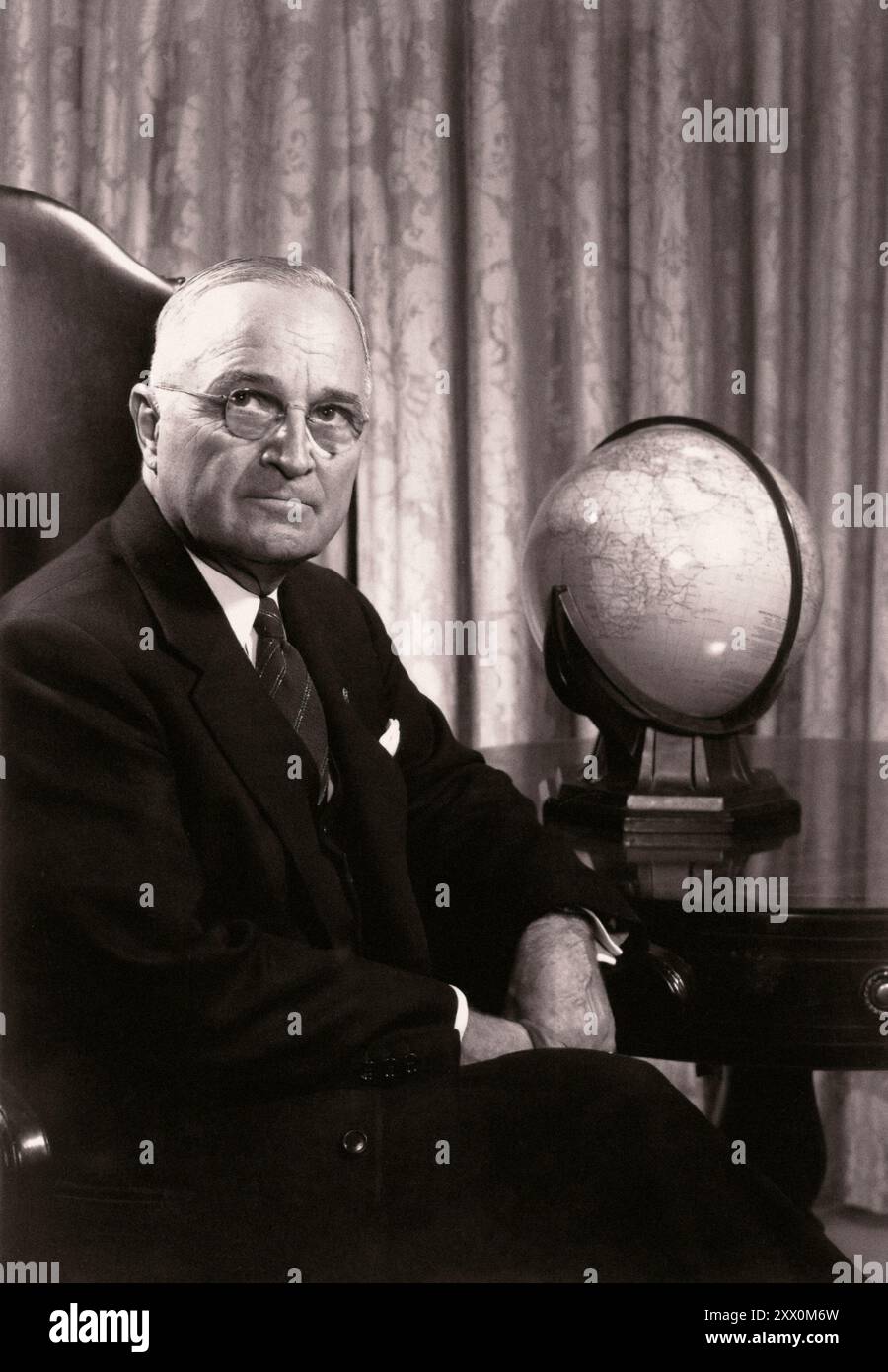 Portrait of seated President Harry S. Truman with globe, taken in White ...