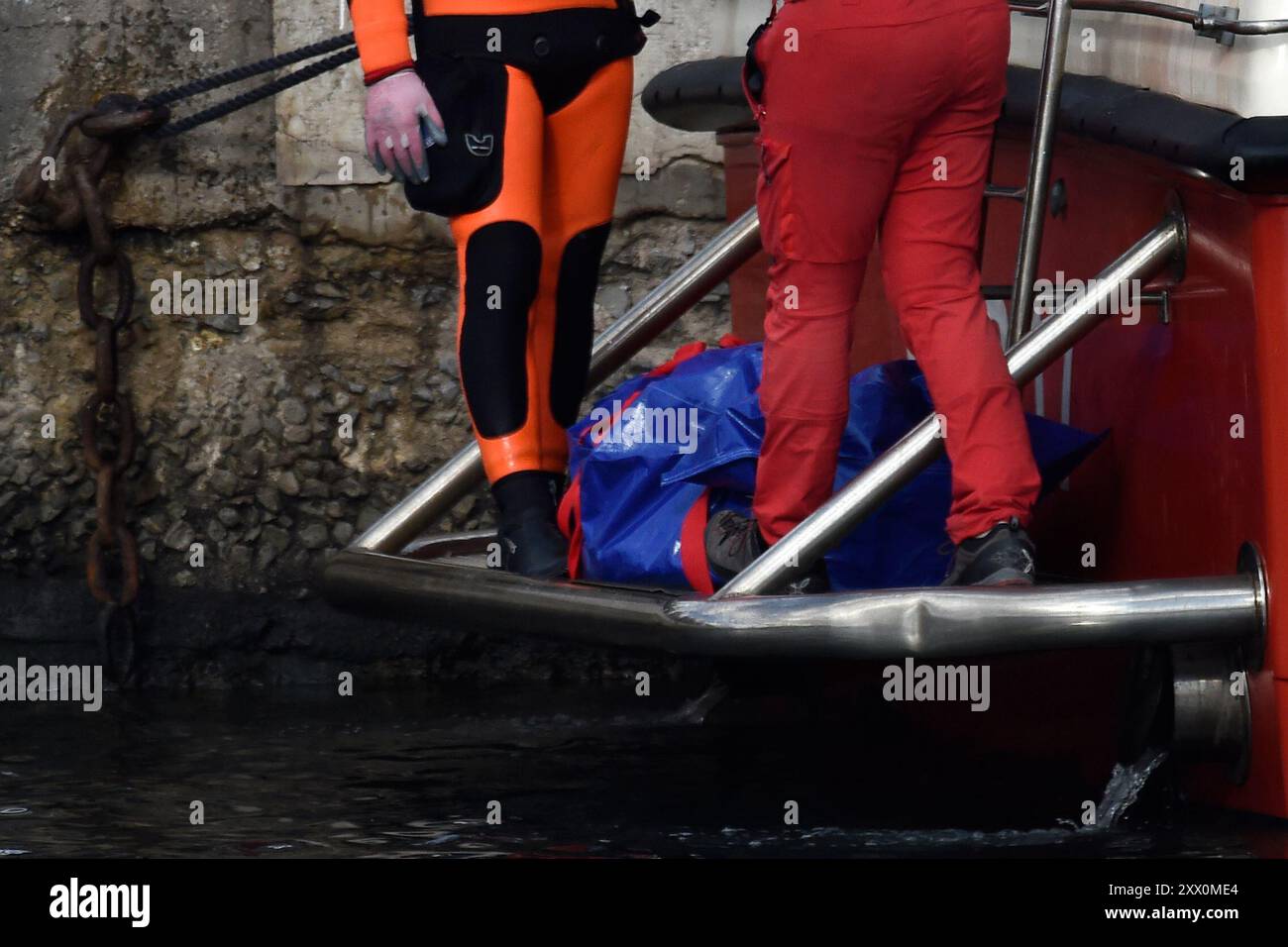 Italian Firefighters scuba divers bring ashore in a blue bag the body ...