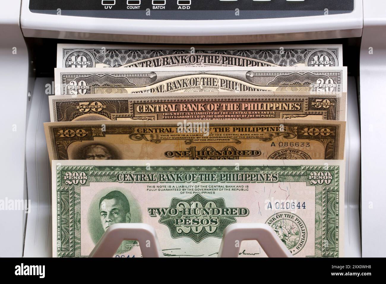 Old Philippine money - peso in the counting machine Stock Photo - Alamy