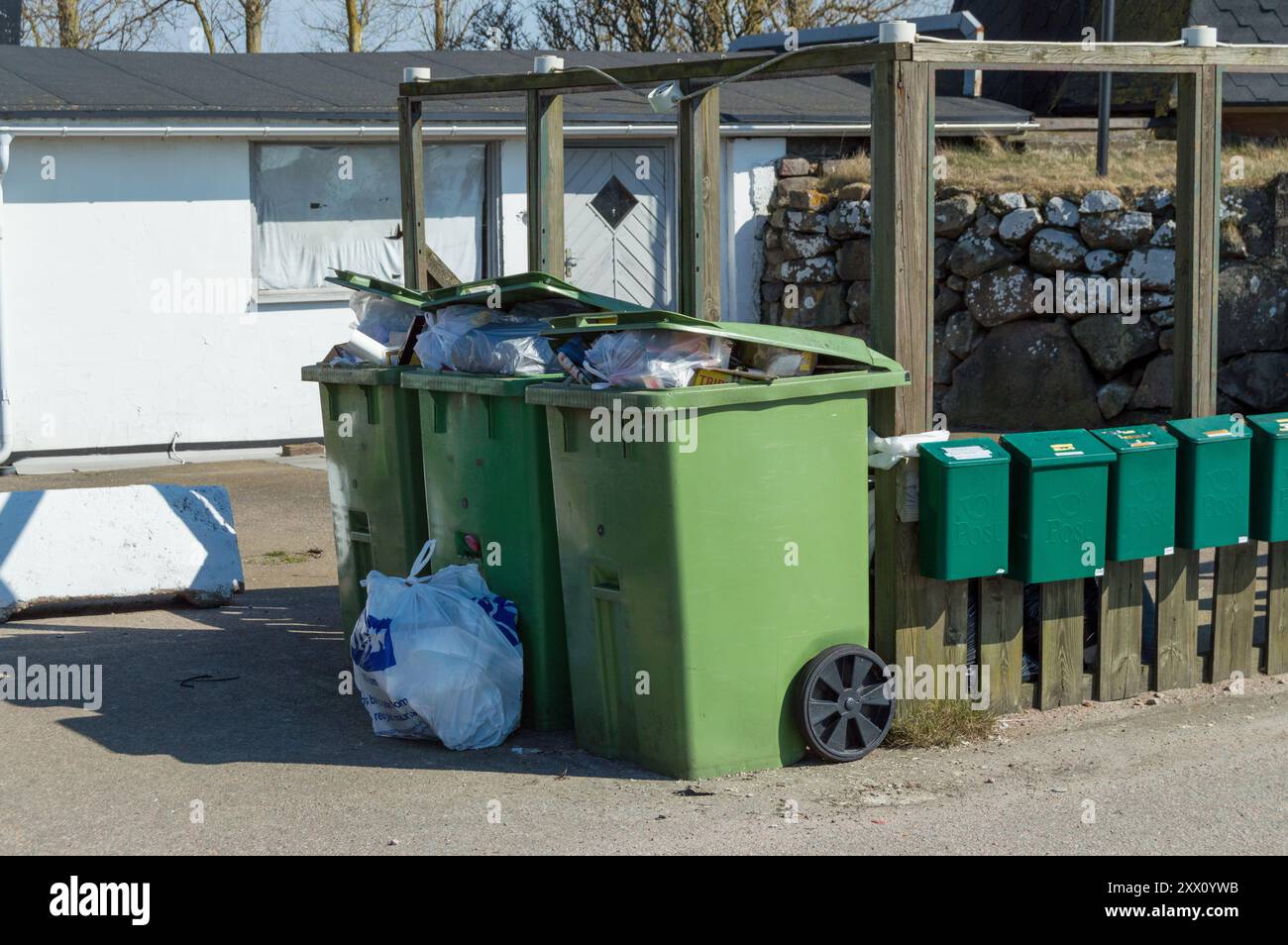 overflowing garbage cans and mailbox Stock Photo - Alamy