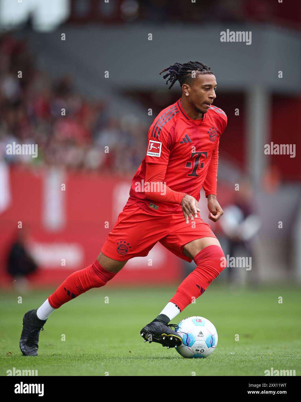 MUNICH, GERMANY - AUGUST 20: Michael Olise of Bayern Muenchen runs with ...