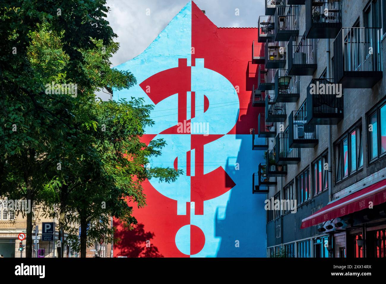 A mural on a Copenhagen wall with the symbol for money, dollars, euros ...