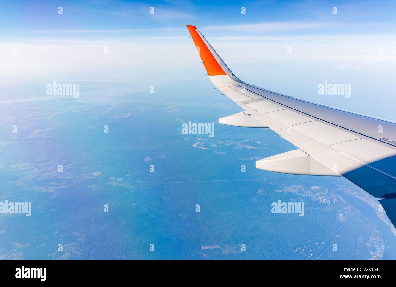 Aerial view from airplane window above green ground. View from the ...