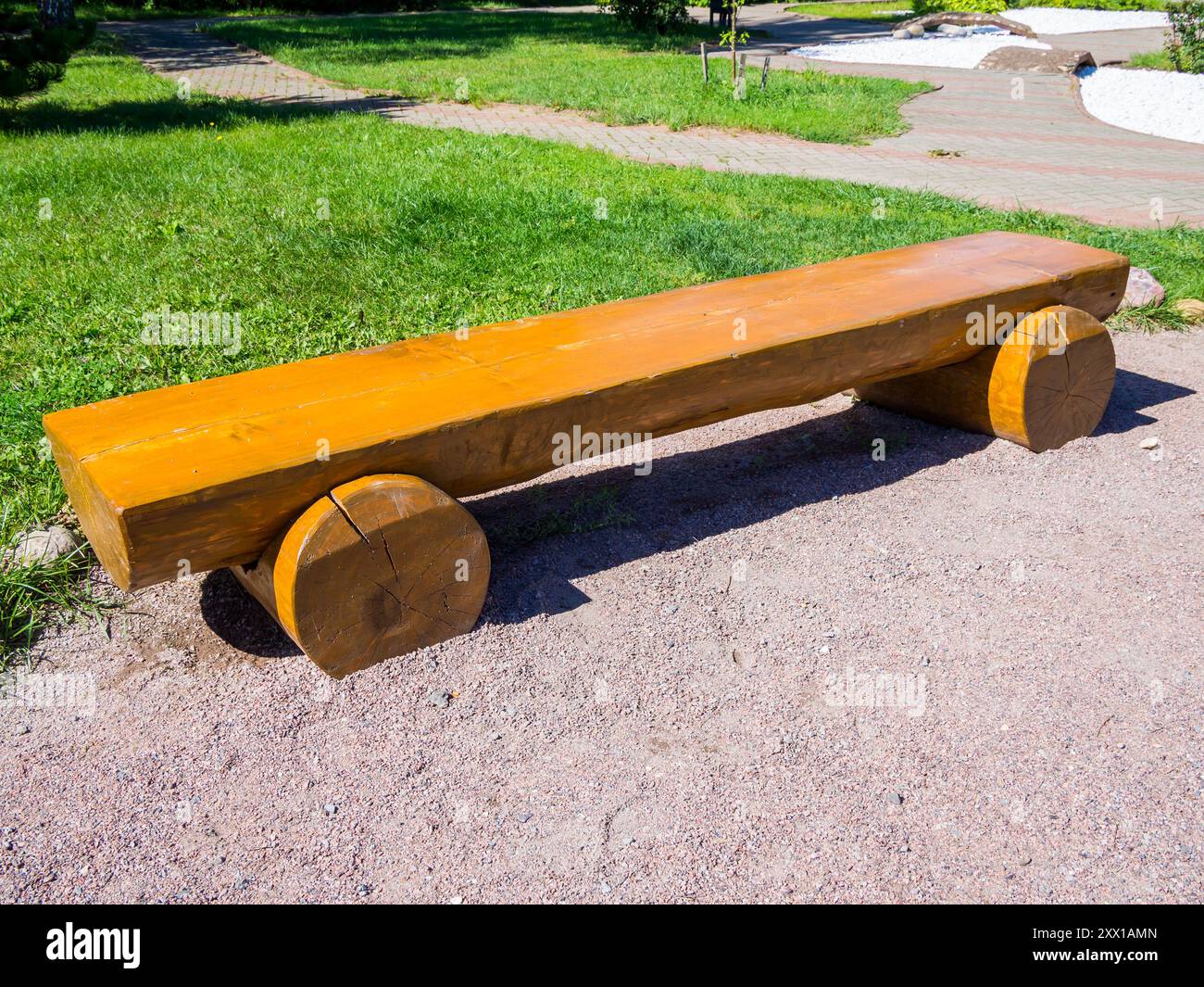 Garden bench made of sawn logs in half Stock Photo - Alamy