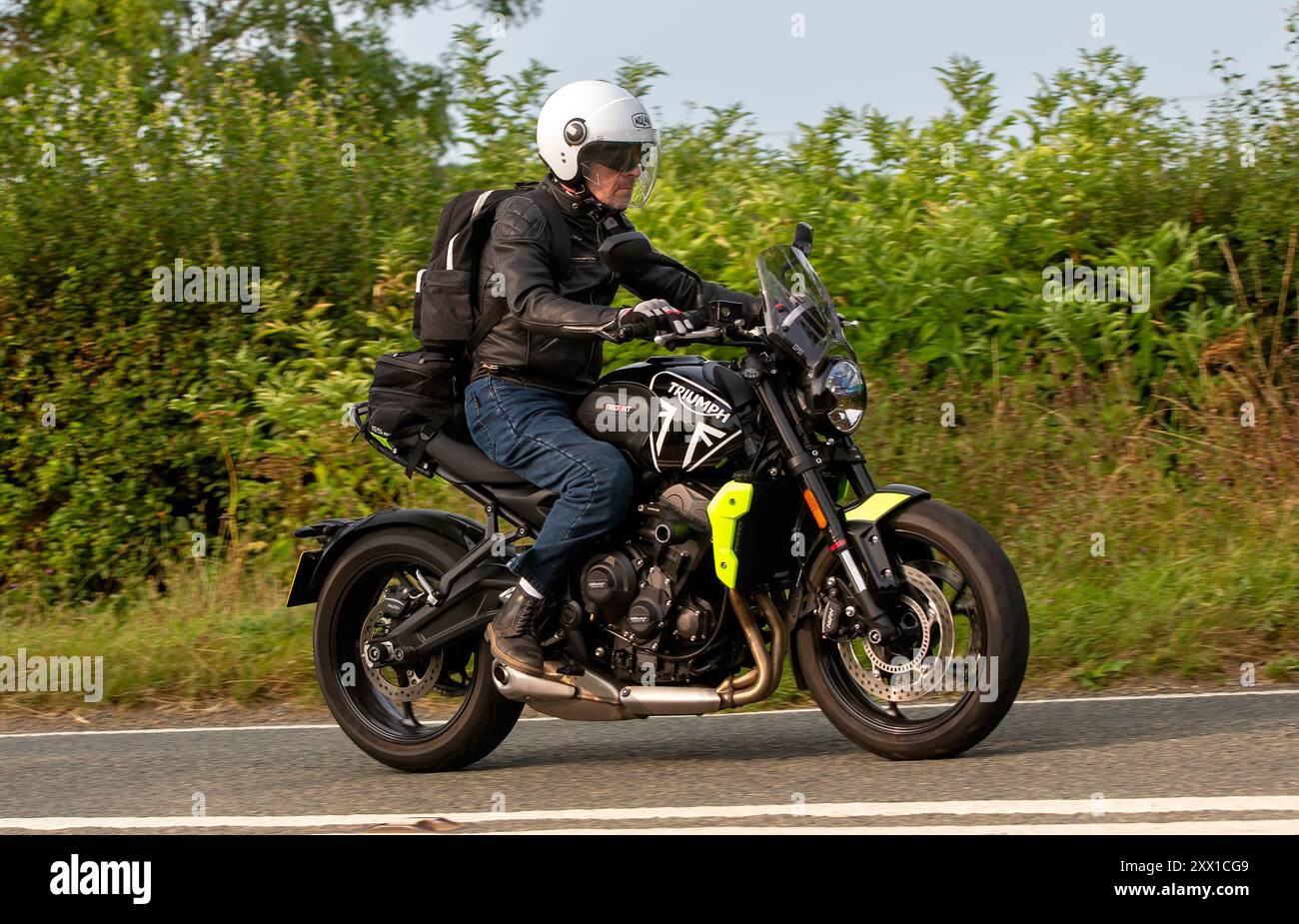 Woburn,Beds,UK - Aug 17th 2024: Man riding a Triumph motorcycle on a ...