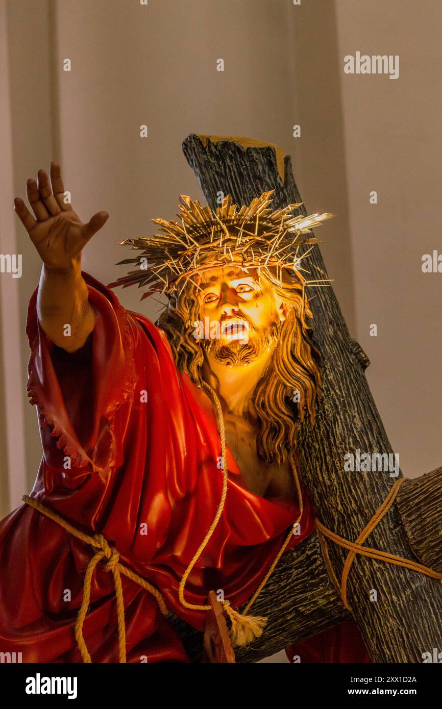 a very old statue of Jesus taken at Poala Parish Church Stock Photo - Alamy