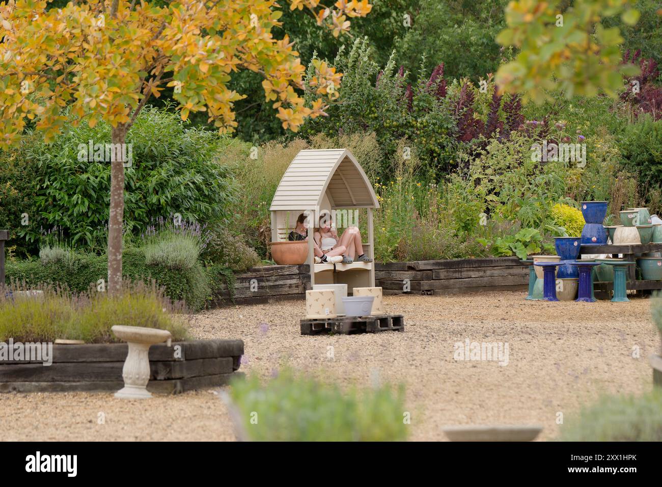 Two children sitting on an arbor seat Stock Photo - Alamy