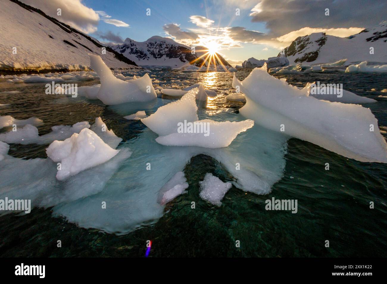 Sunset over bergy-bits of ice off the shore of Danco Island, Antarctica ...