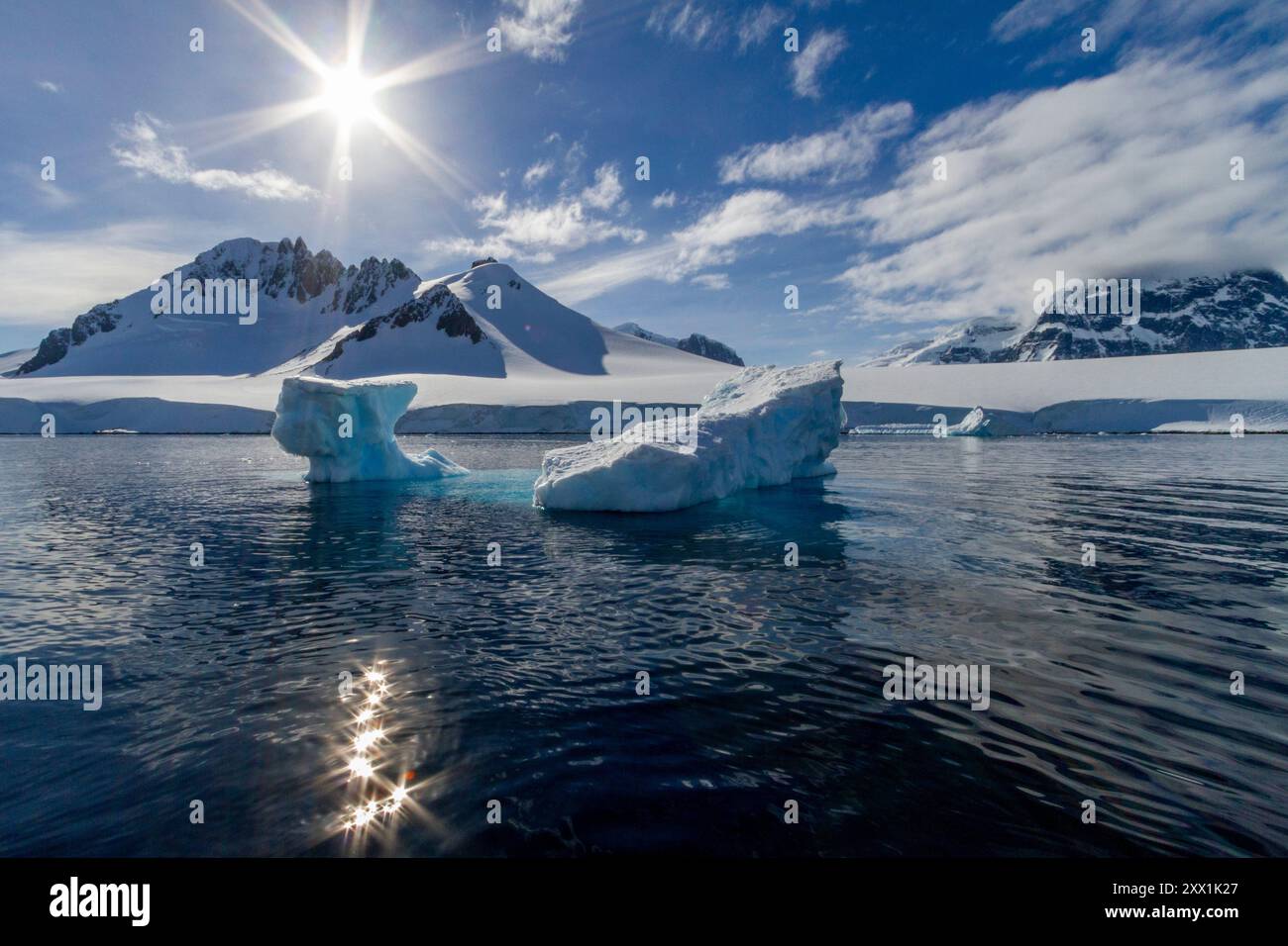 View of calm seas and reflected mountains surrounding Damoy Point in ...