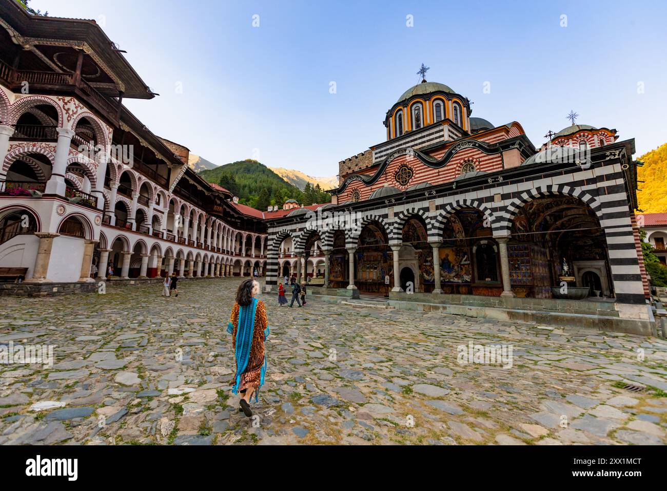 Woman walking towards monastery hi-res stock photography and images - Alamy