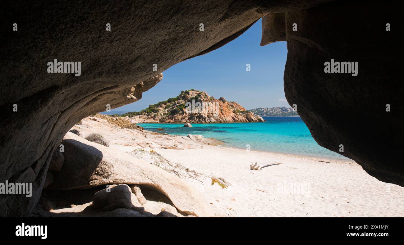 View through cave entrance across the waters of Cala Corsara to the ...