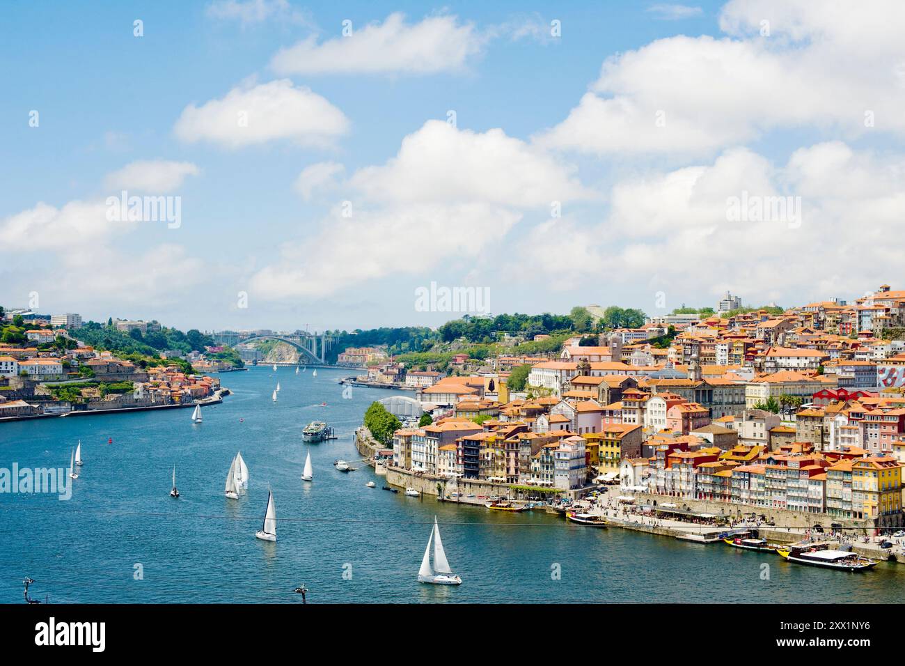 A view of Porto's historic centre and the Duoro River flowing towards ...