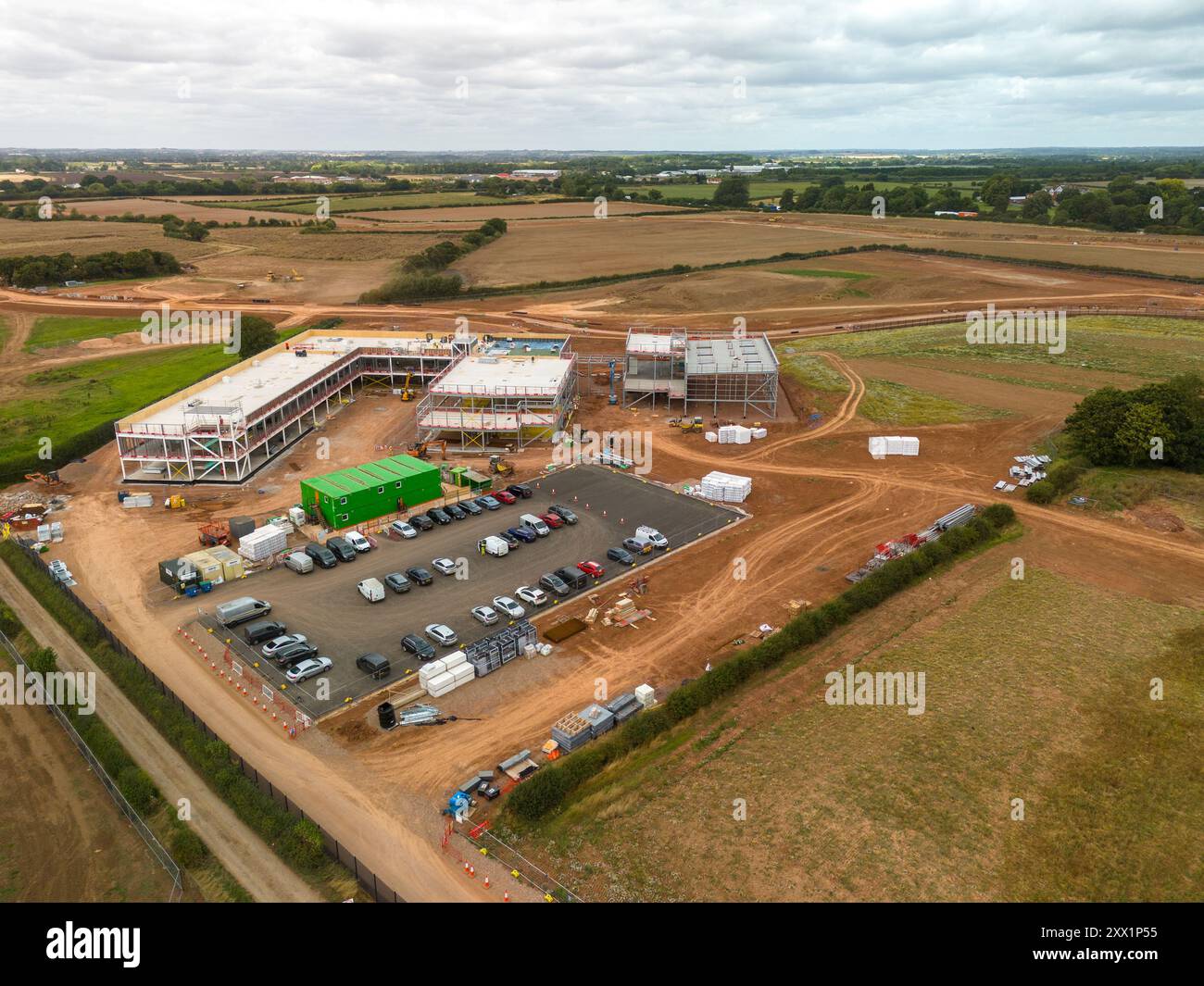 Aerial view of a modern school under construction on a large ...
