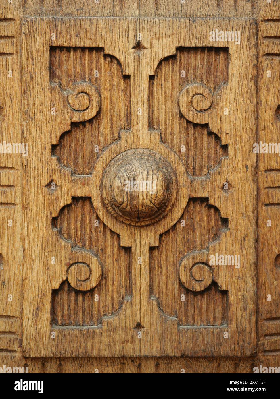 A detailed view of a highly ornate wooden door showcases intricate ...