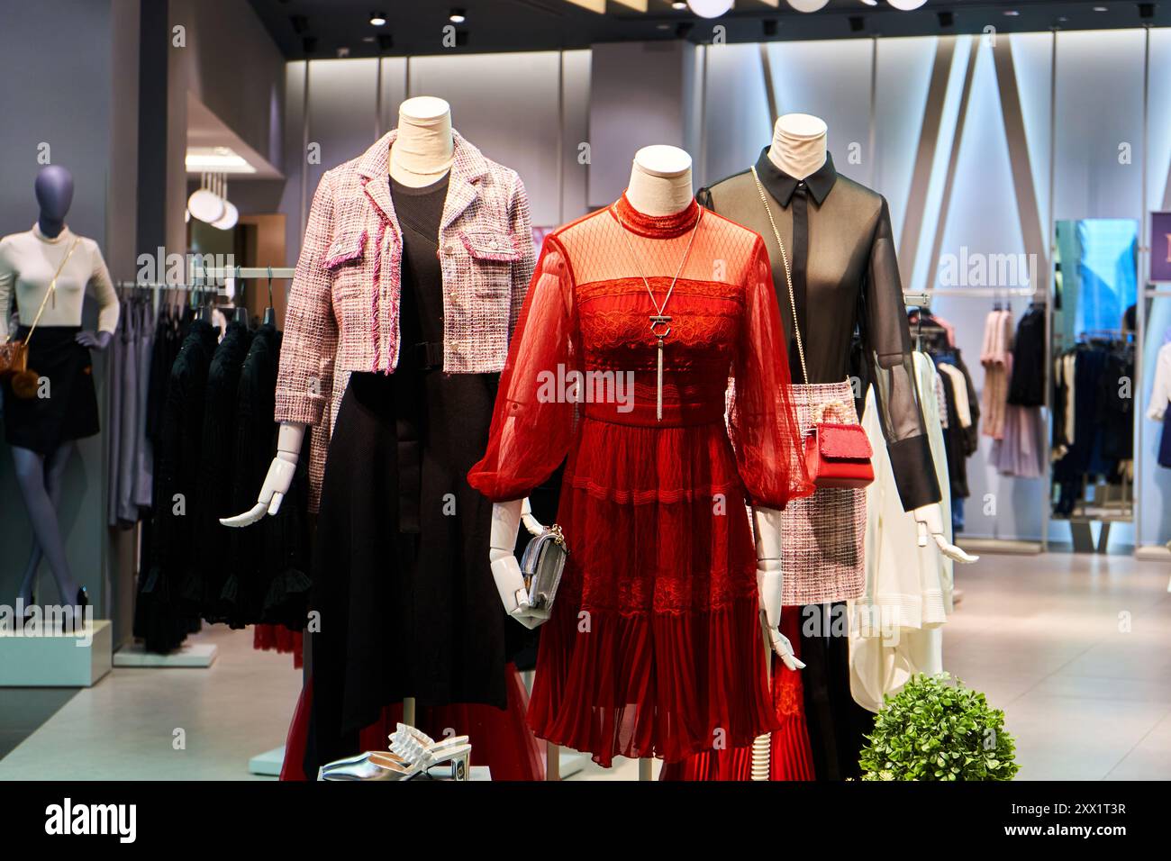 A showcase with mannequins in a clothing store in a shopping center ...