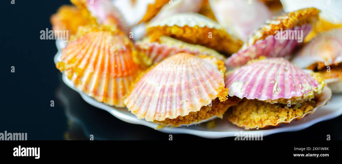A plate of food with shells on it. The shells are pink and white. The ...