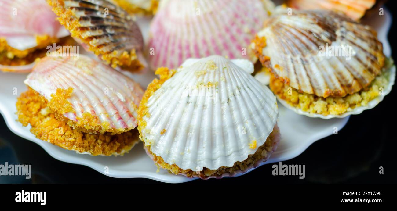 A plate of food with shells on it. The shells are pink and white. The ...